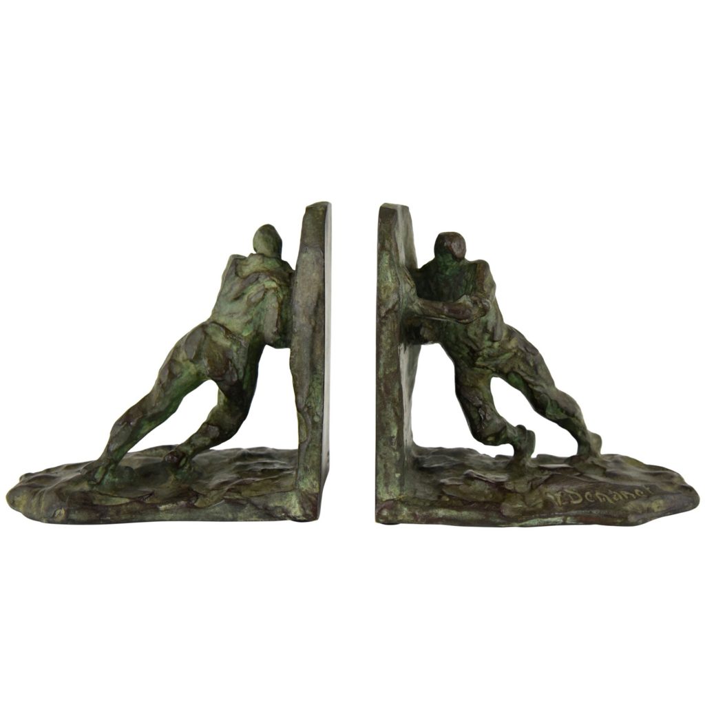 Art Deco bronze bookends pushing men - Deconamic