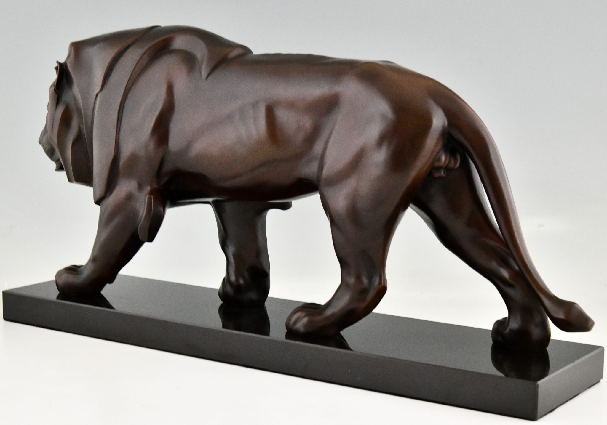 Art Deco style sculpture of a walking lion. - Deconamic