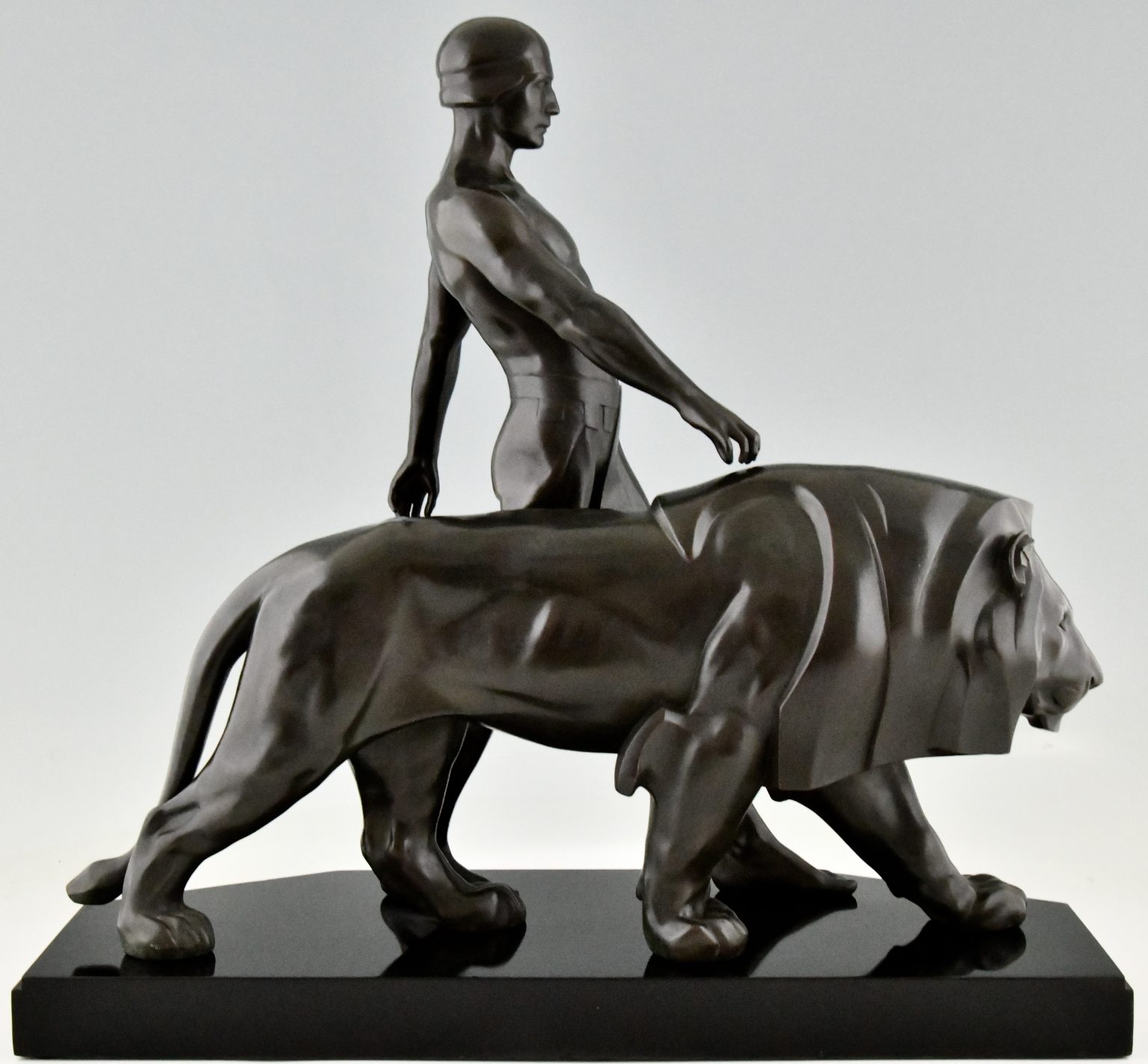 Art Deco sculpture of a male nude walking with lion Belluaire - Deconamic